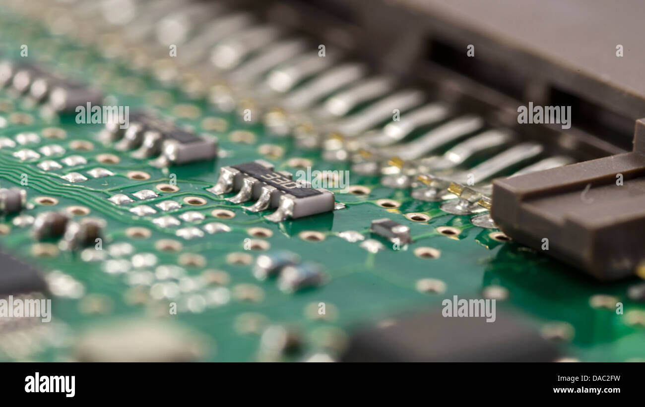 Green Electrical Circuit Board with microchips, conductors, and ...