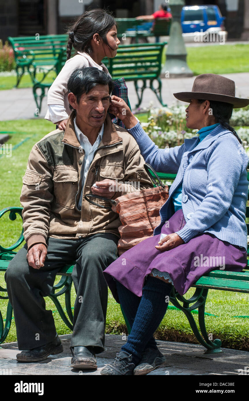 Inca native couple with daughter child sitting on bench, Plaza de Armas ...
