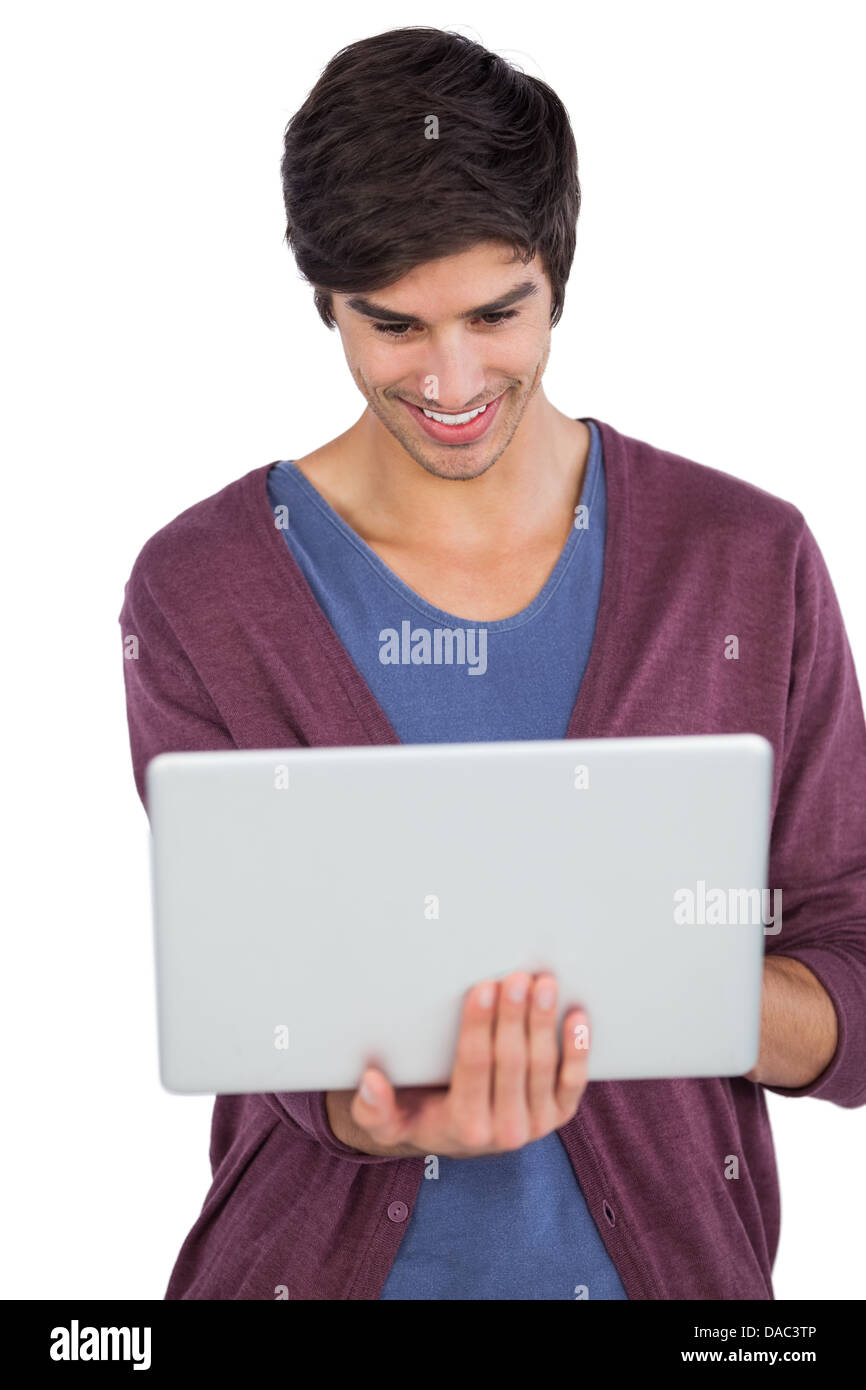 Smiling man using a laptop Stock Photo - Alamy