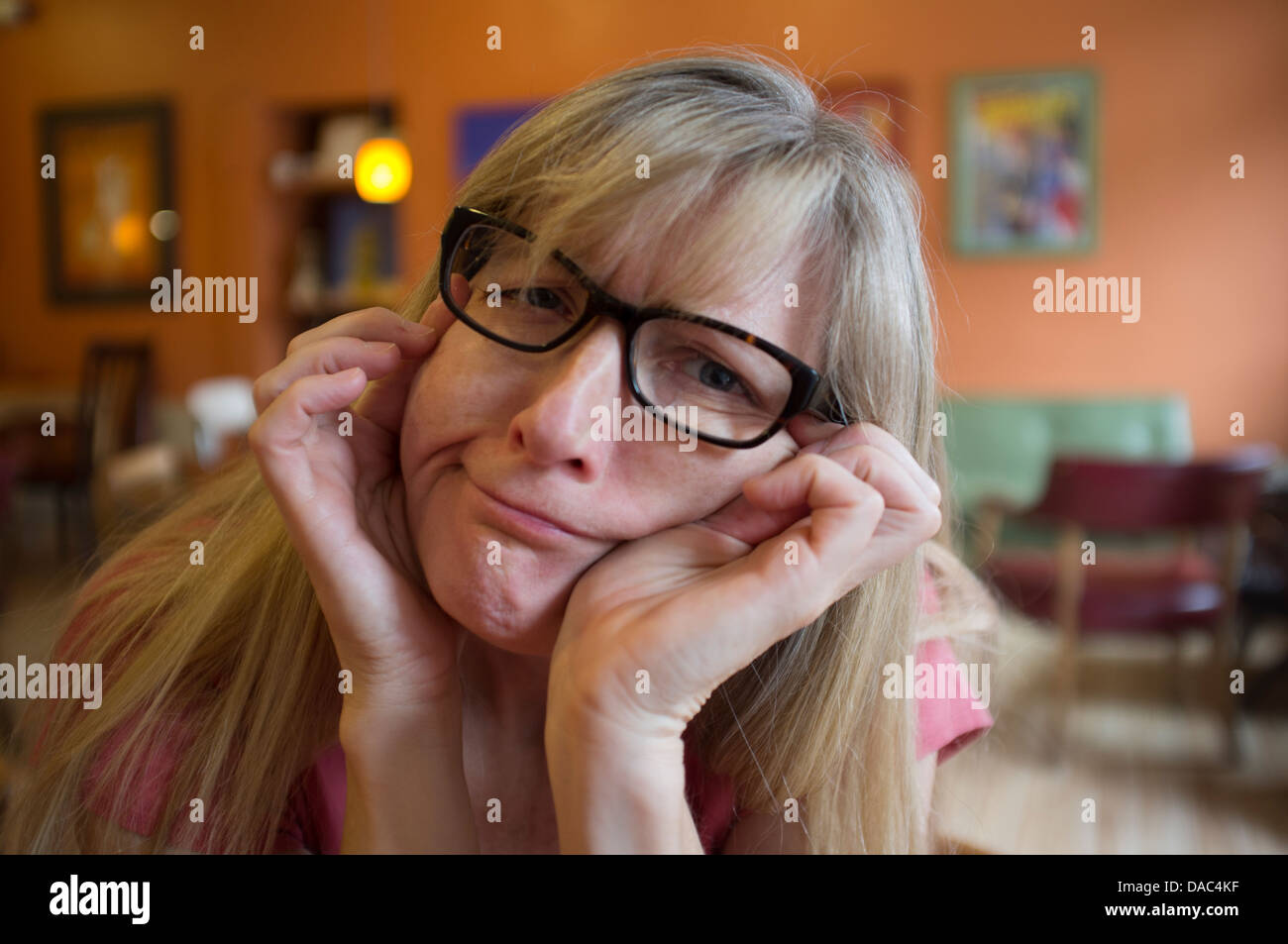 Female wearing glasses making a goofy expression to the camera Stock ...