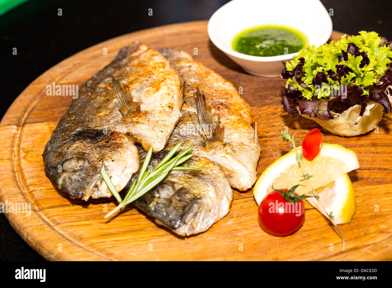 sea fish cooked on the grill Stock Photo - Alamy