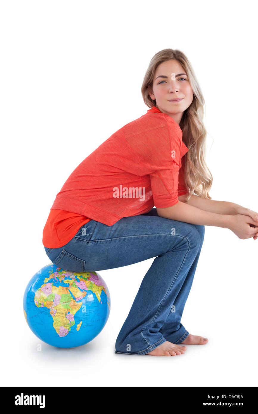 Woman sitting on a globe Stock Photo - Alamy