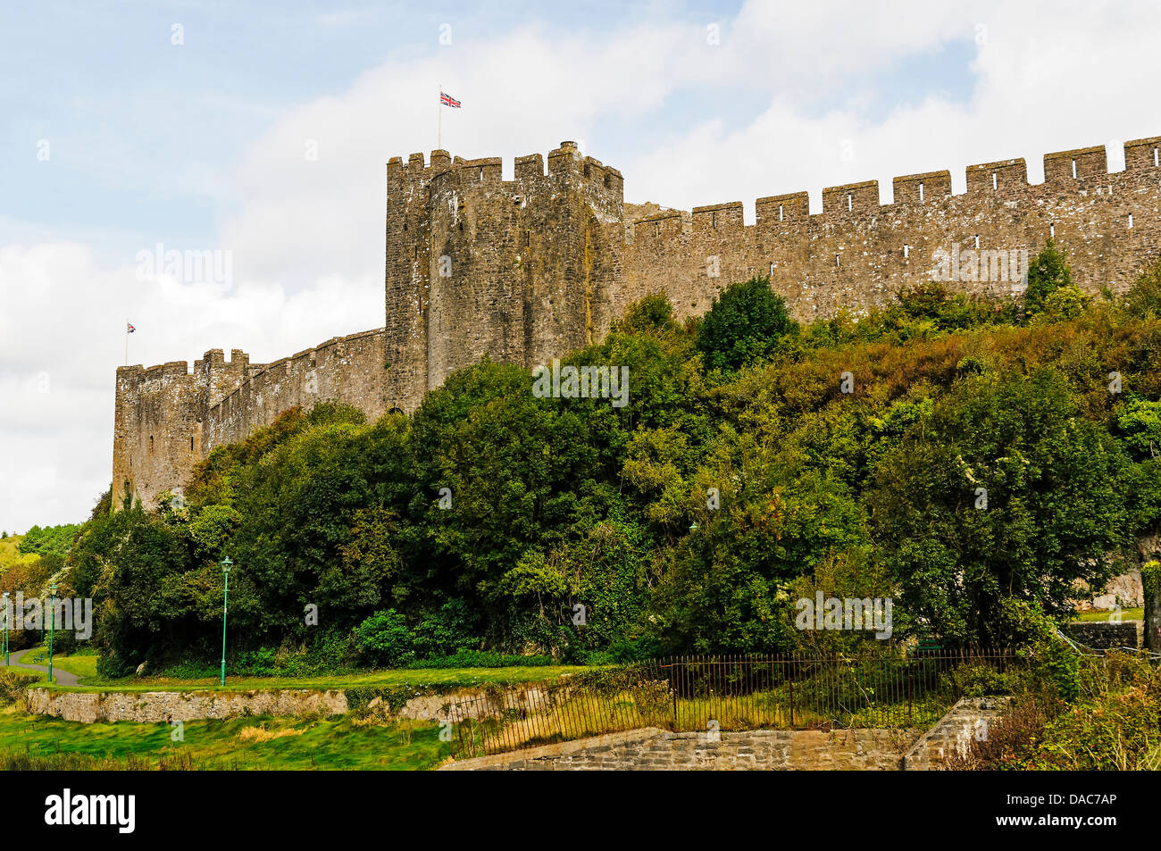 The outer curtain walls of Pembroke Castle protected by formidable ...