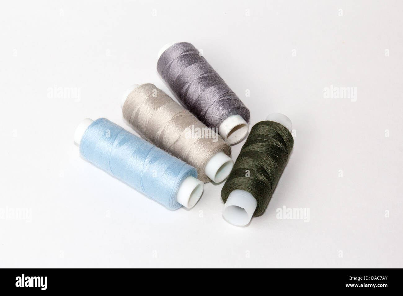 Multy coloured bobbins of thread on white background Stock Photo - Alamy