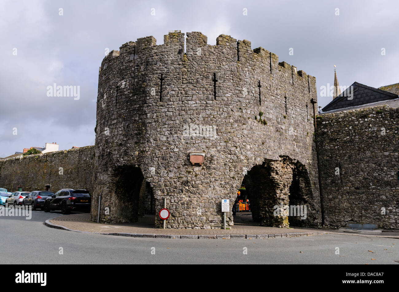 Cars parked alongside the medieval town walls of Tenby up to the old ...