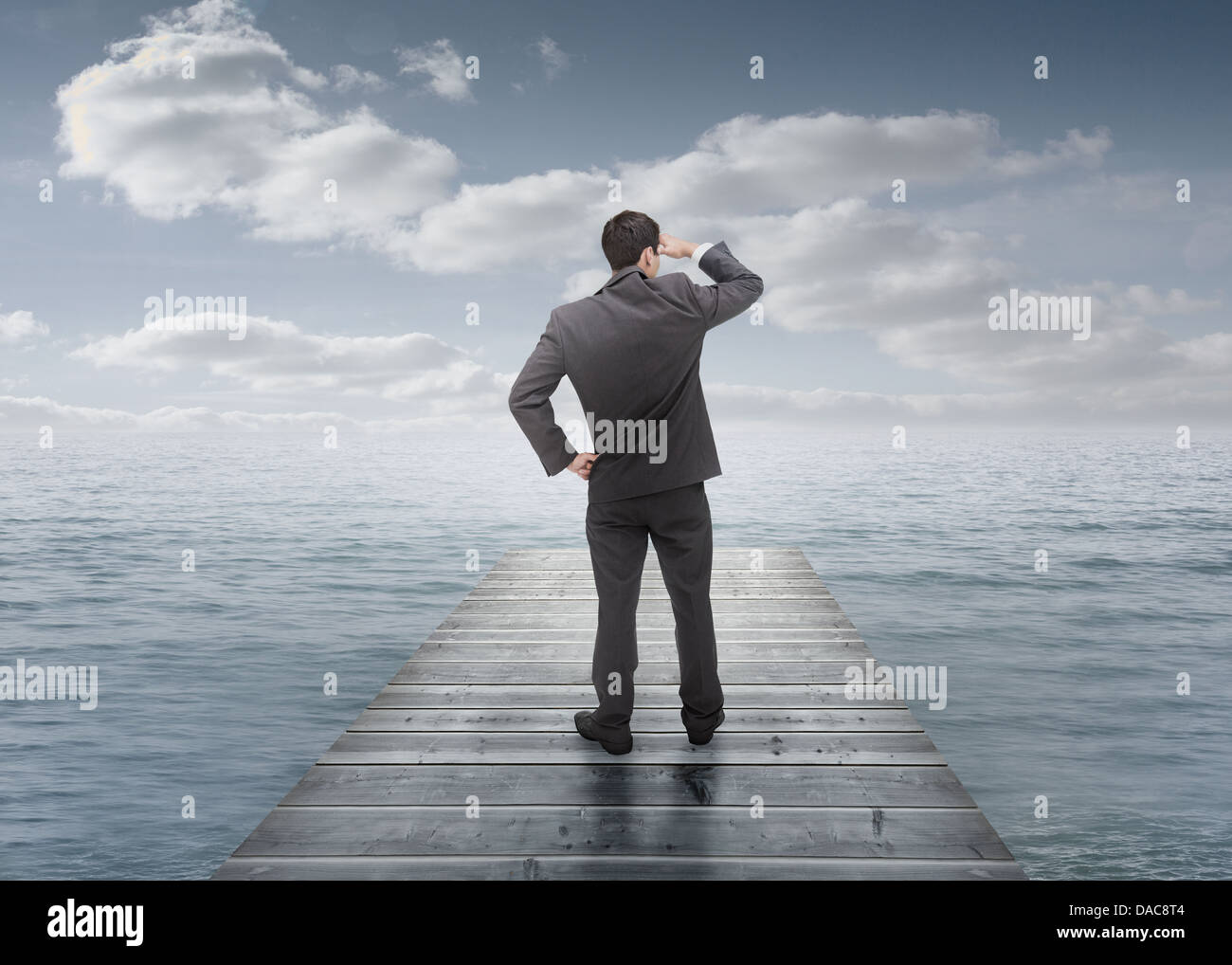 Businessman standing on a bridge Stock Photo - Alamy