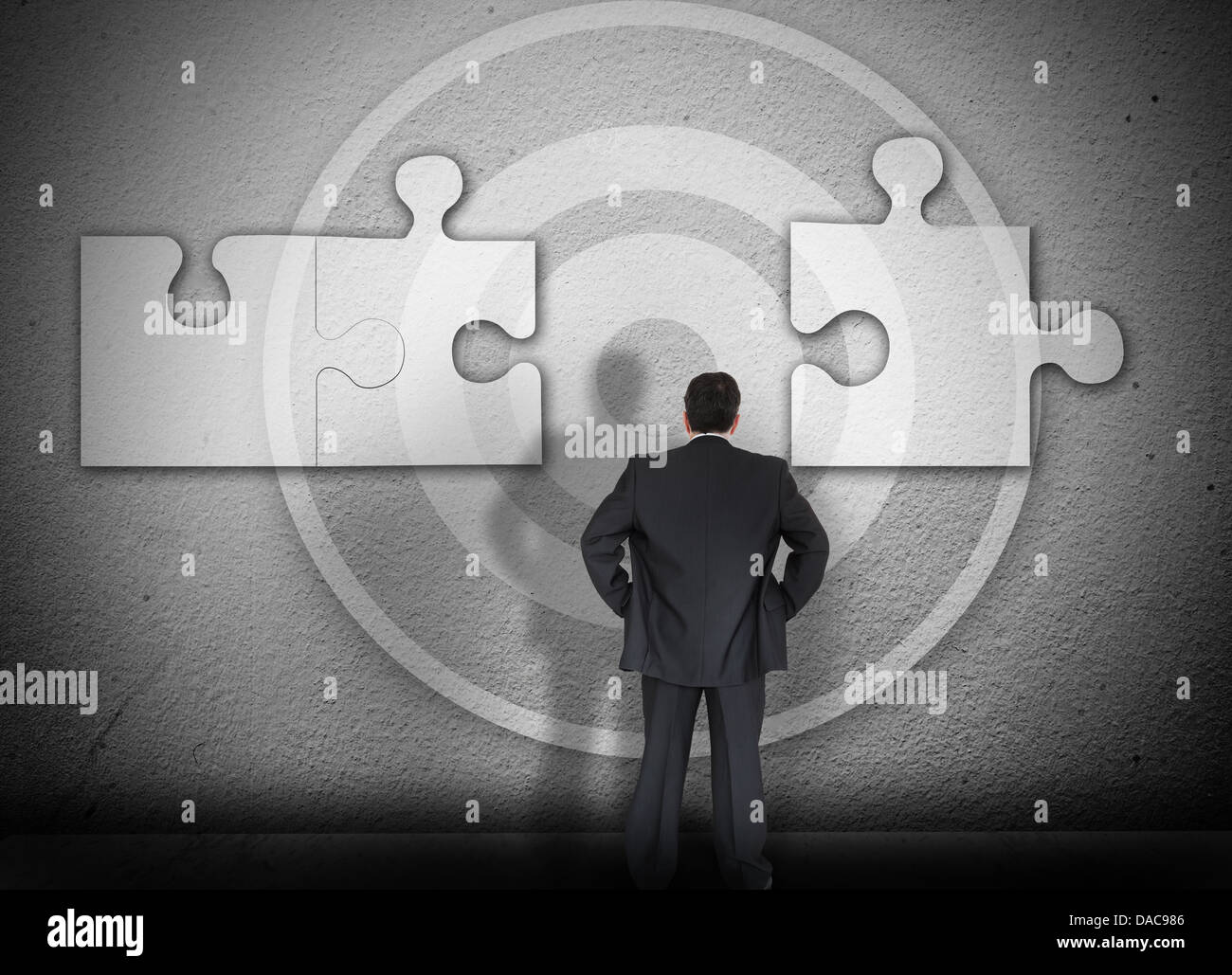 Businessman solving jigsaw puzzle Stock Photo - Alamy