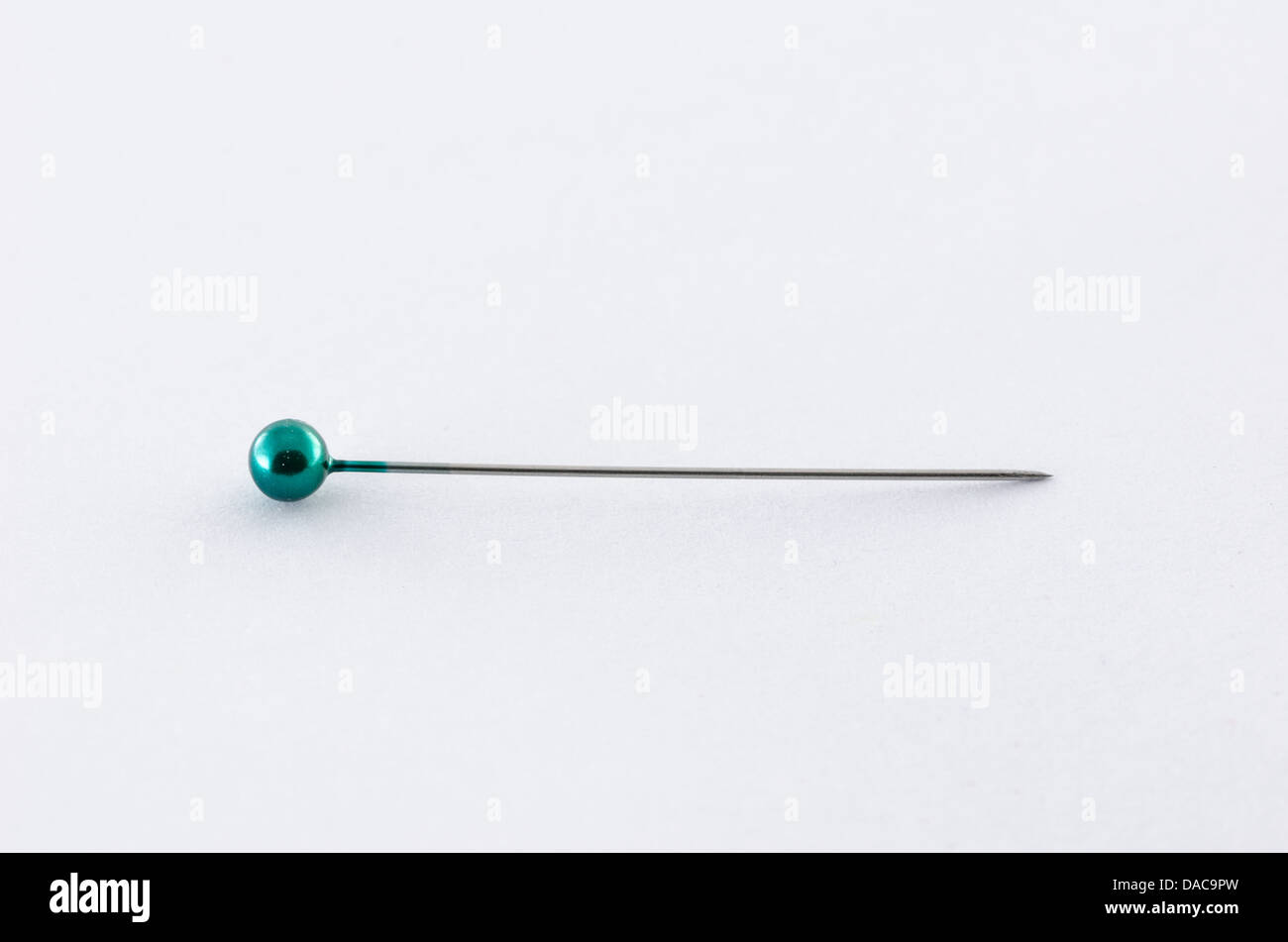 Pin in white background in the embroidery crafts concept Stock Photo ...