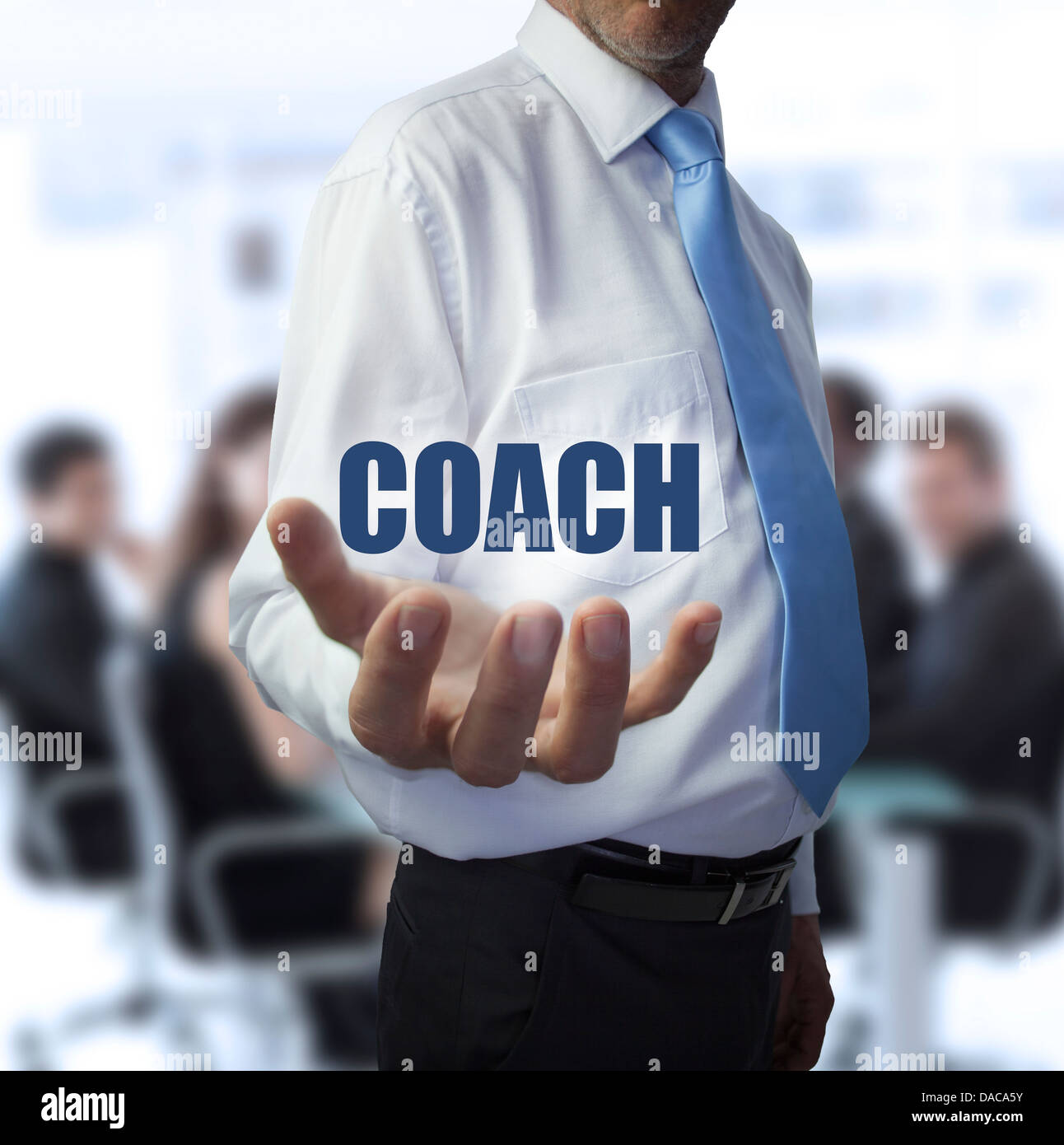 Elegant businessman holding the word coach Stock Photo - Alamy