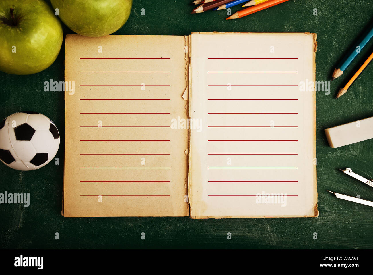 Open book and school supplies, chalkboard in background Stock Photo - Alamy