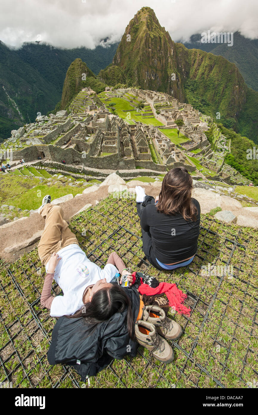 Hikers relaxing at Machu Picchu unesco world heritage site ancient Inca ...