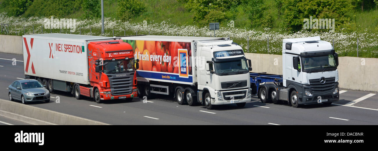 Three lorries and a car overtaking on a four lane section of the M25 ...