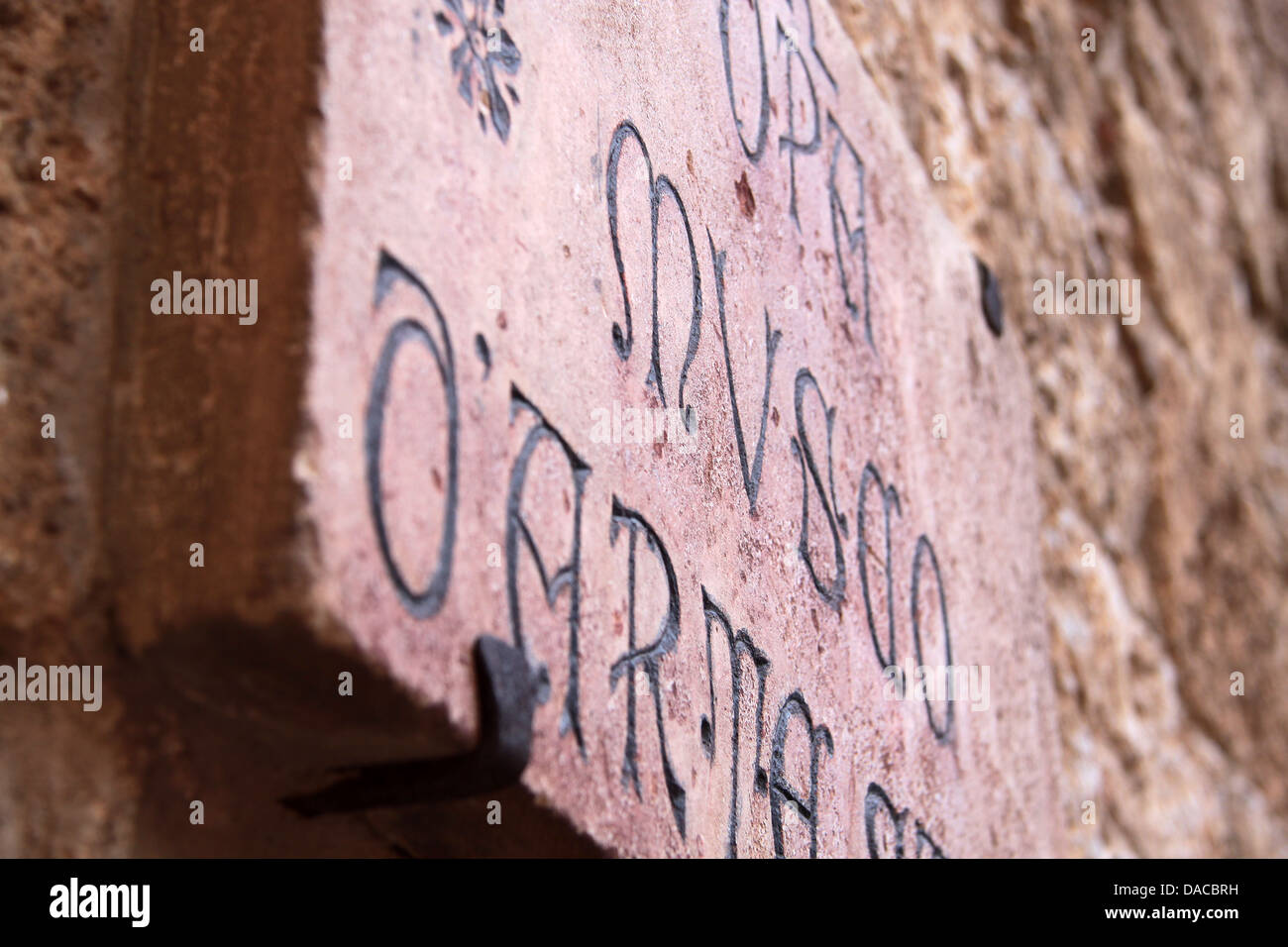 Italian characters on a stone tablet in San Gimignano in Tuscany Stock ...