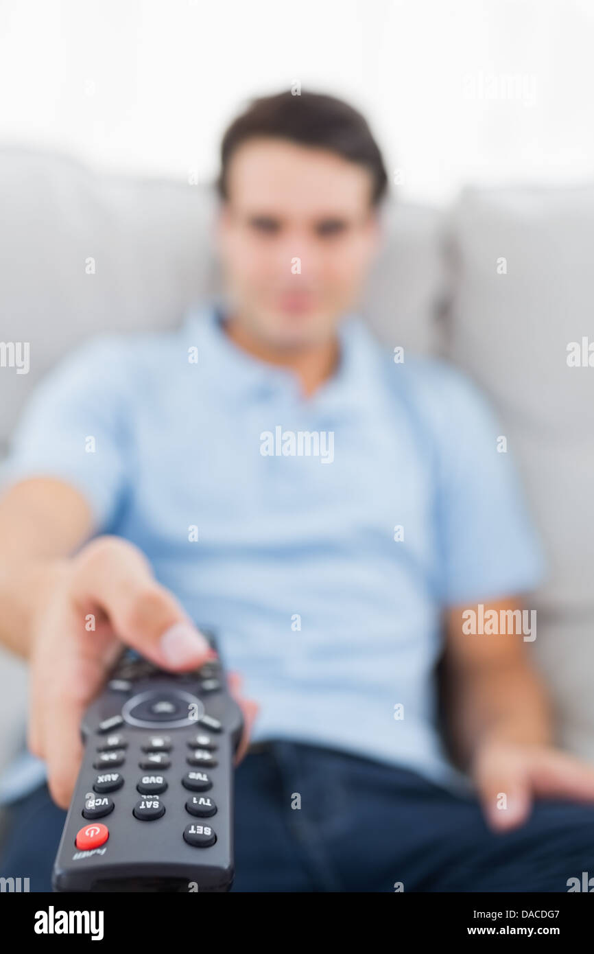 Portrait of a man changing channel Stock Photo - Alamy