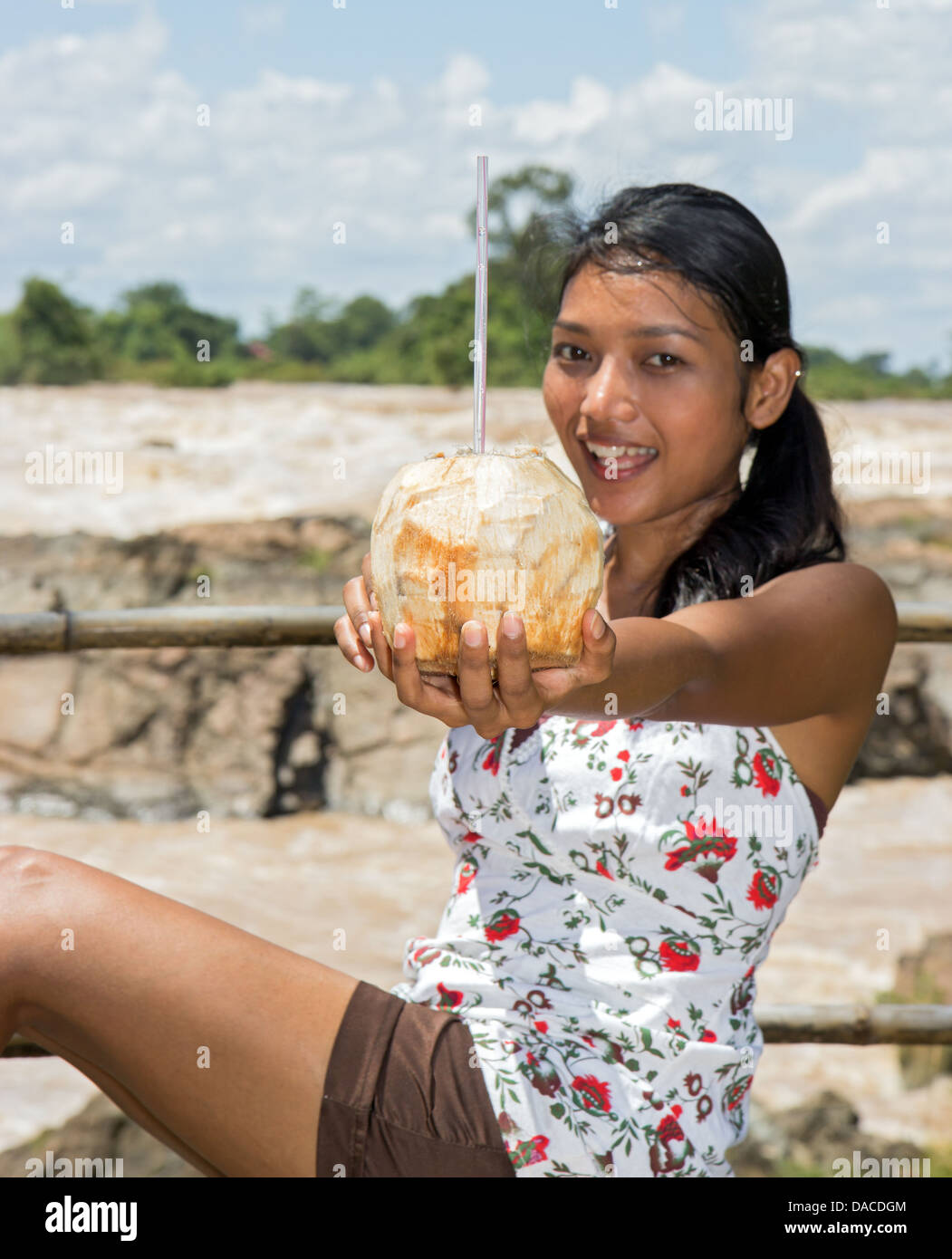 Young woman resting with coconut Stock Photo - Alamy