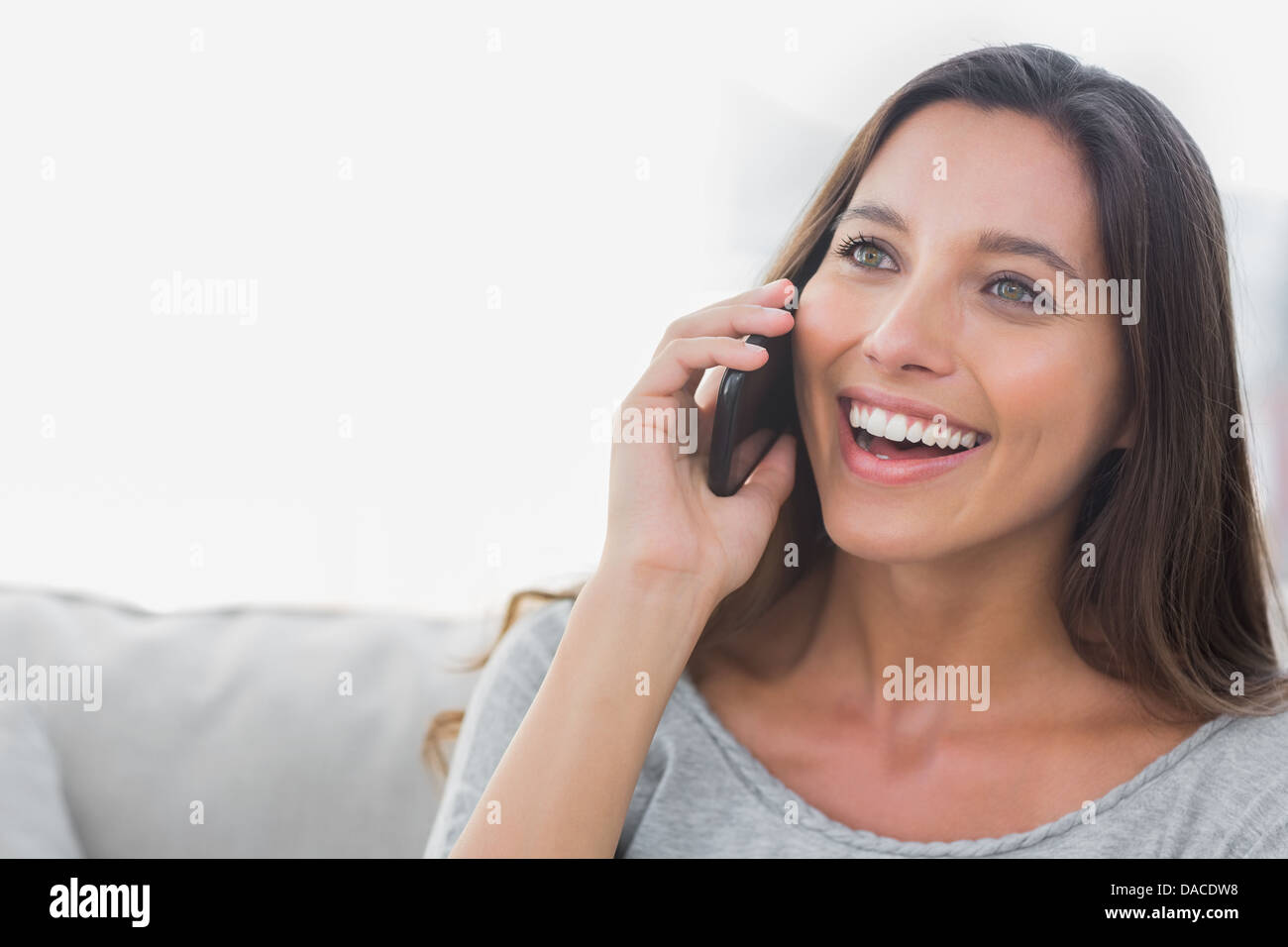Woman laughing while she is on the phone Stock Photo - Alamy