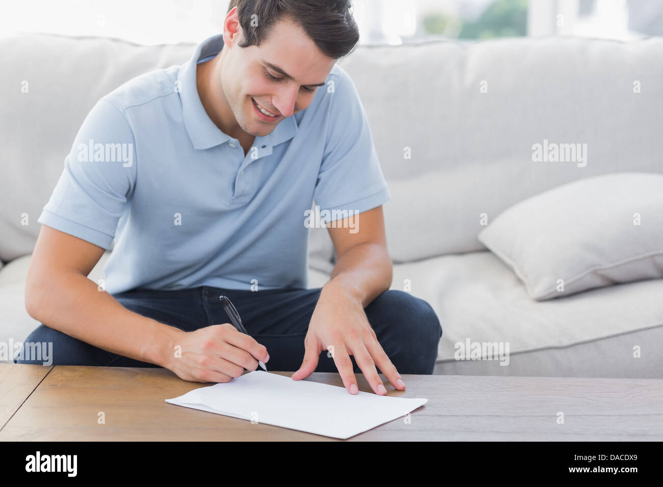 Man writing on a paper Stock Photo - Alamy