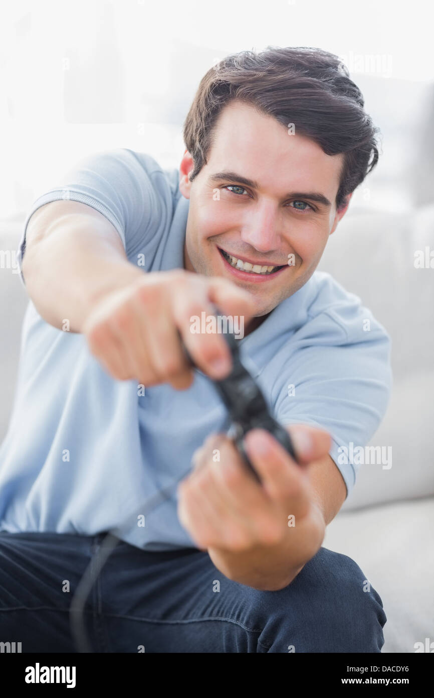 Portrait of a cheerful man playing video games Stock Photo - Alamy
