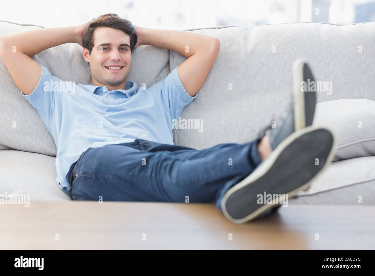 Portrait of a smiling man relaxing Stock Photo - Alamy