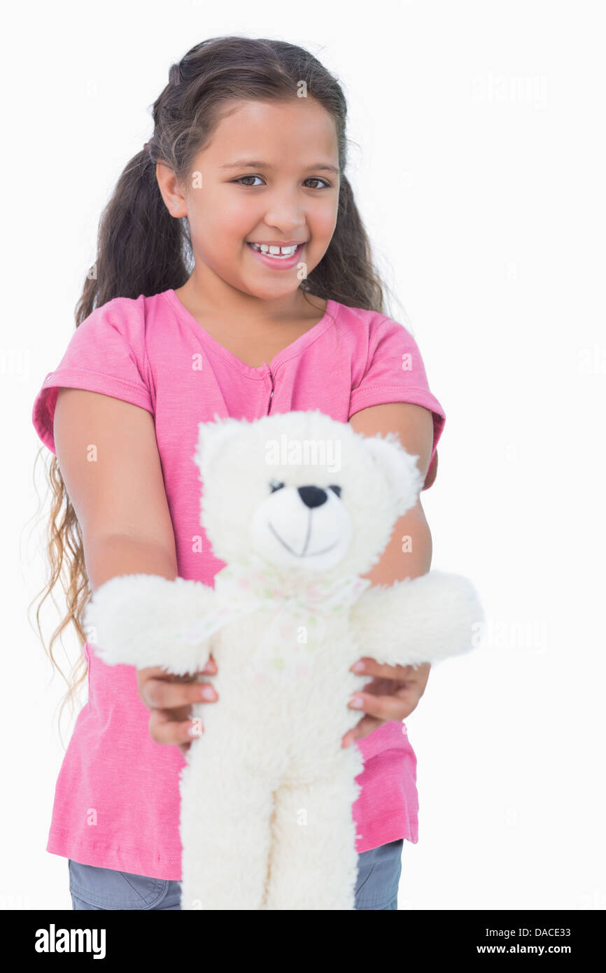 Smiling little girl showing her teddy bear to camera Stock Photo - Alamy