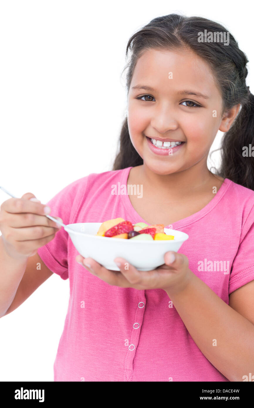 Little girl eating fruit salad Stock Photo - Alamy