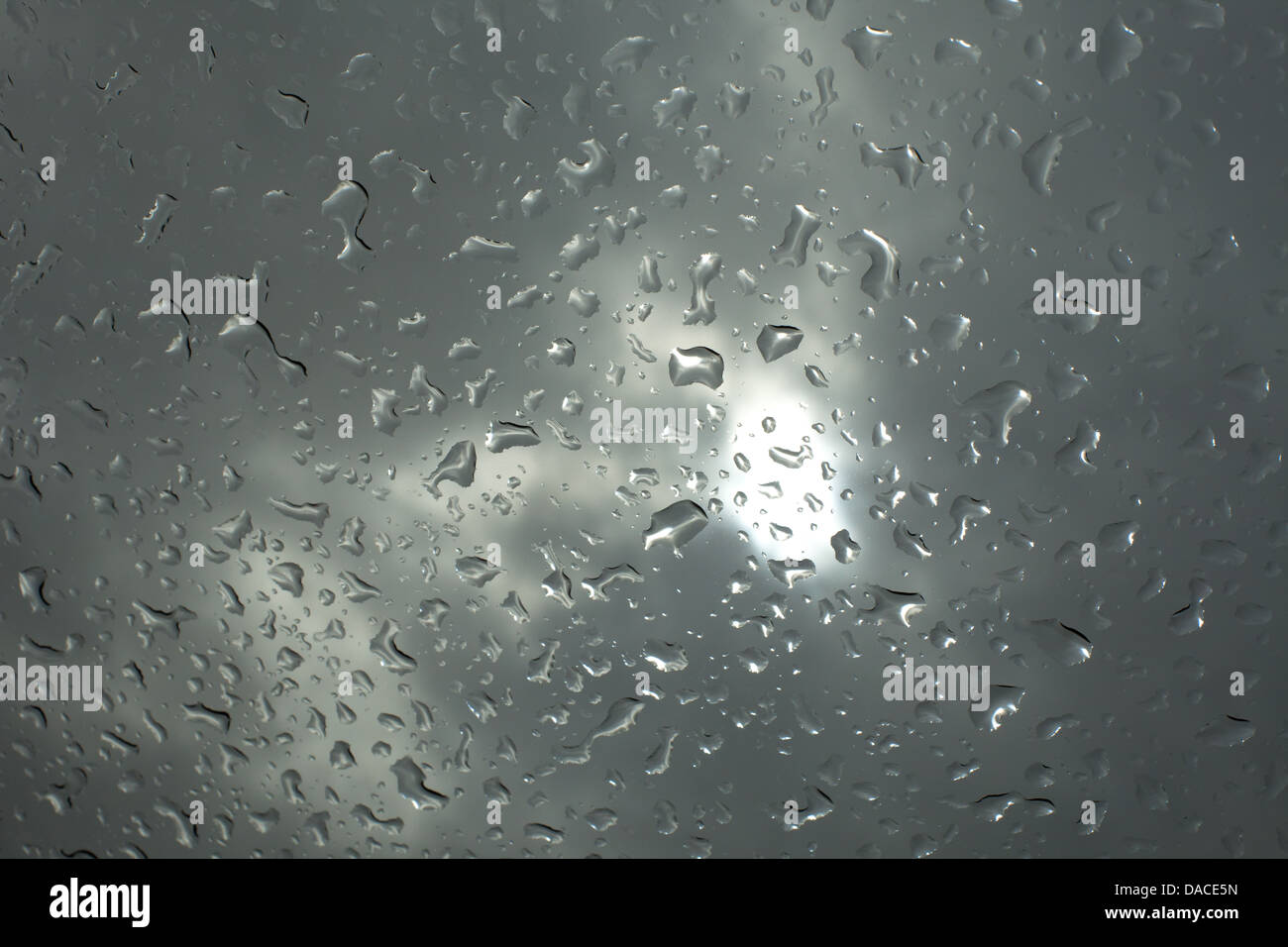 sun through the clouds and window with rain drops Stock Photo - Alamy