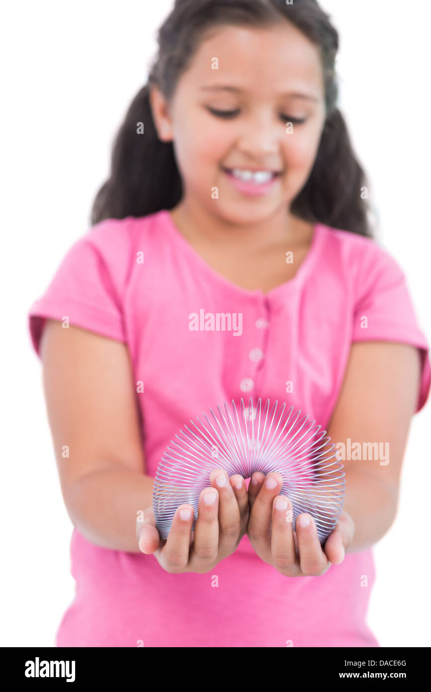 Little girl looking at spring in her hands Stock Photo - Alamy