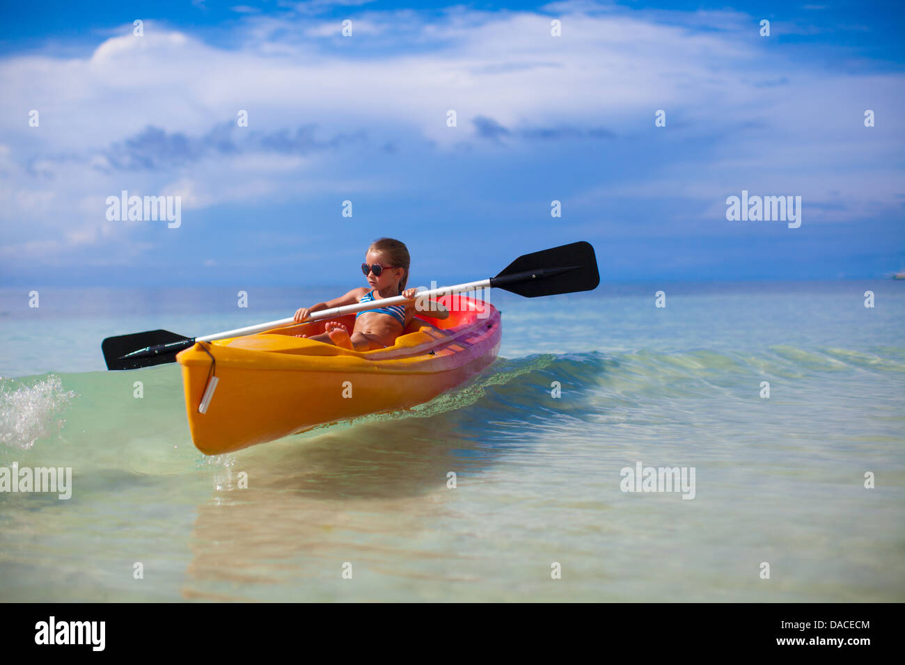 little cute girl rowing a boat in clear sea Stock Photo - Alamy