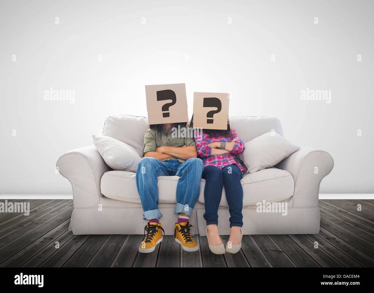 Funny couple wearing boxes with question mark on their head Stock Photo ...