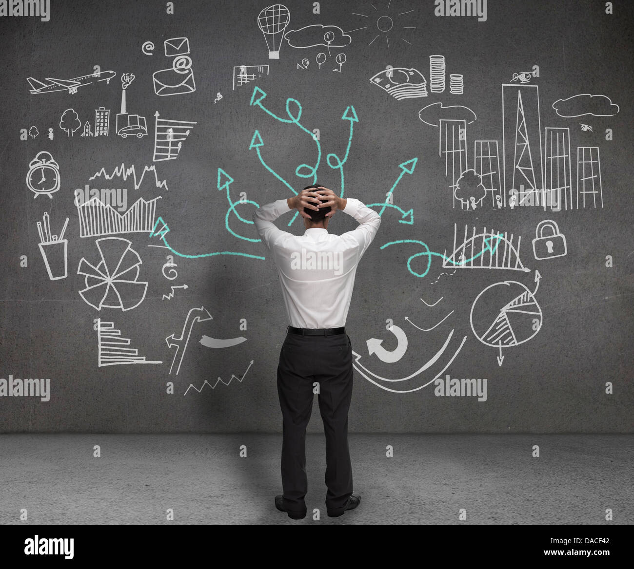 Businessman looking at drawings Stock Photo - Alamy
