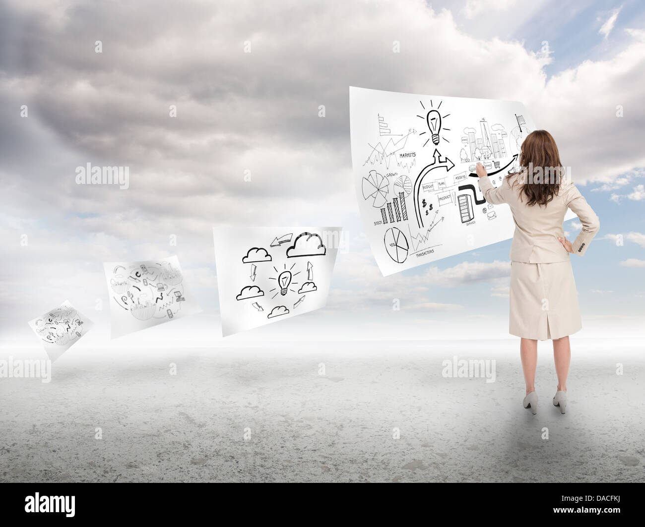 Businesswoman drawing on a paper floating Stock Photo - Alamy