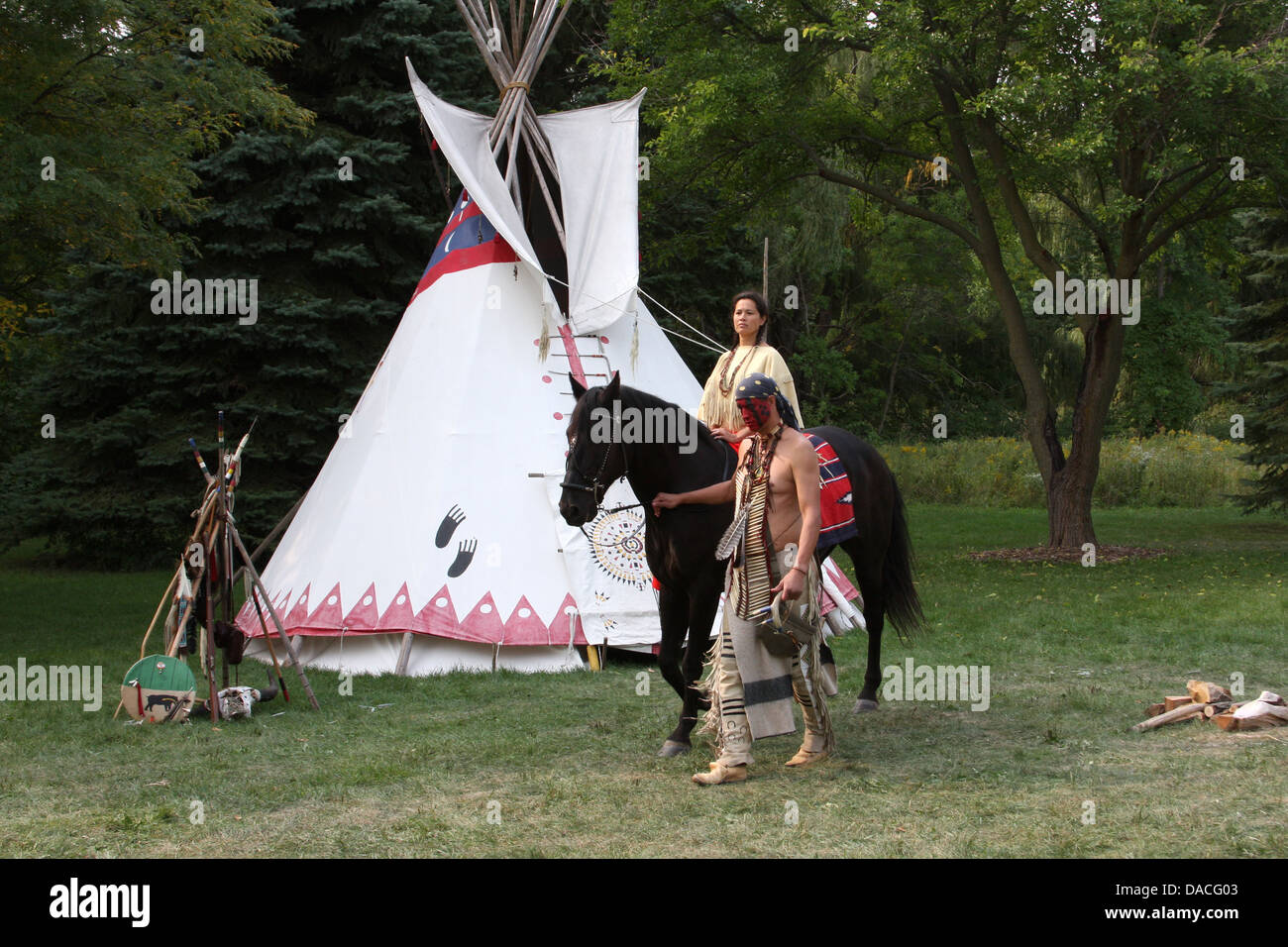 Native American Indian man walking woman on horseback Stock Photo - Alamy