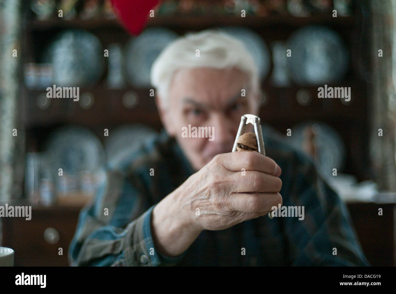 Man cracking a nut hi-res stock photography and images - Alamy
