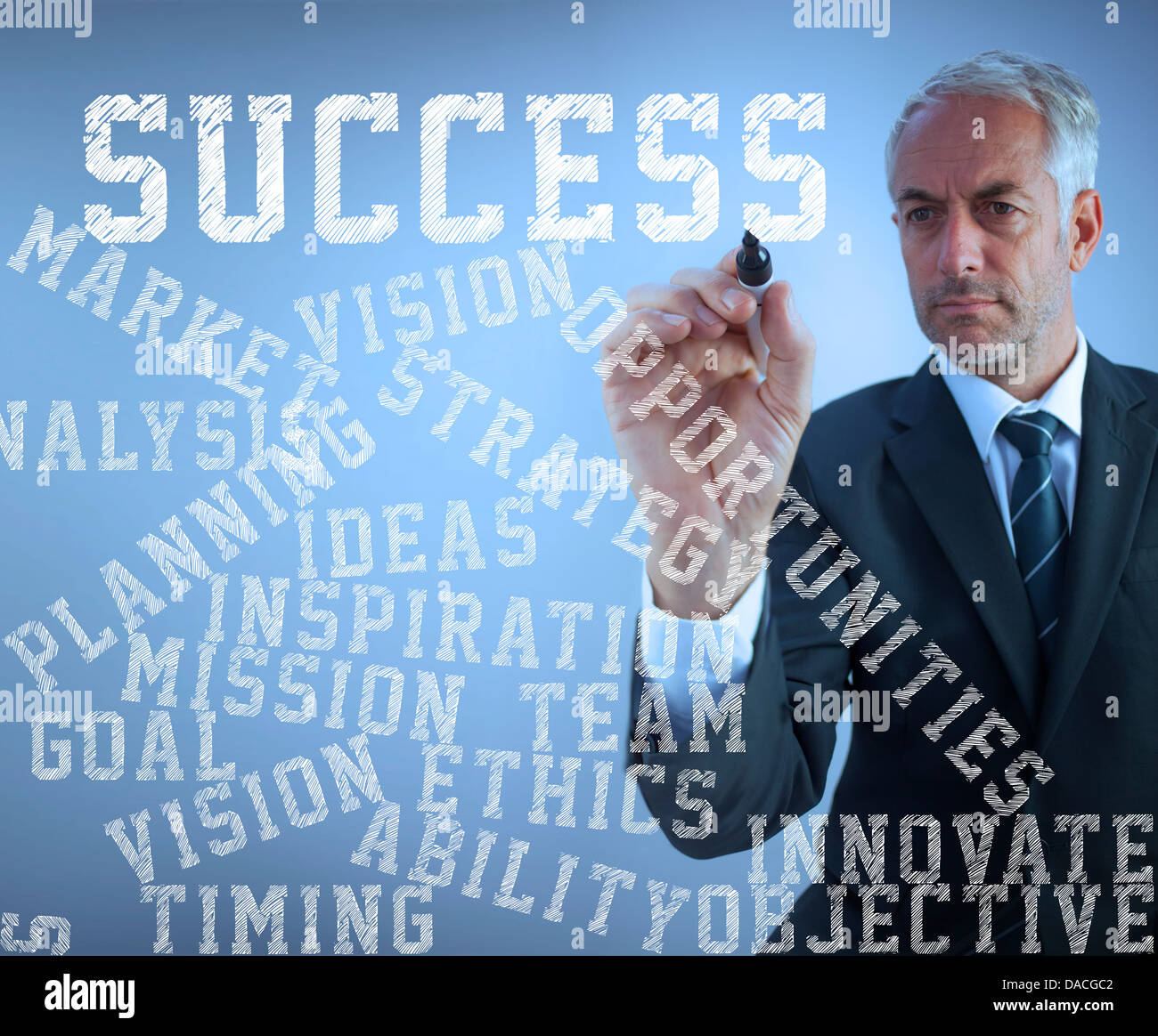 Attractive businessman writing success terms with a marker Stock Photo ...