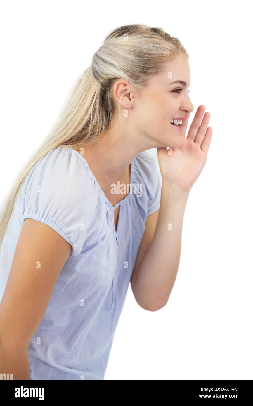 Smiling blonde woman telling a secret Stock Photo - Alamy