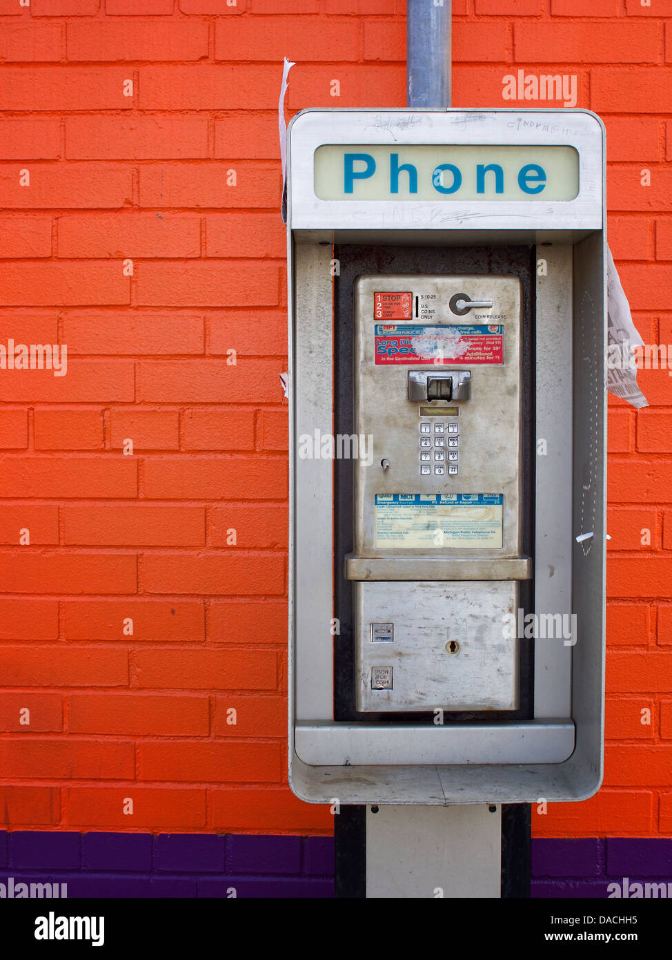 A damaged, abandoned public phone booth in Detroit, missing the handset ...