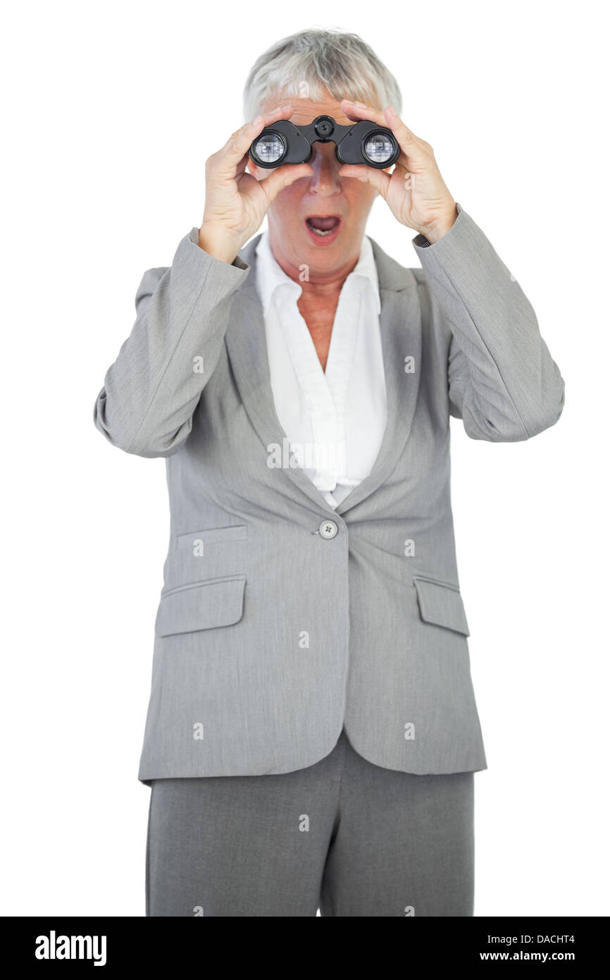 Astonished businesswoman looking at something through binoculars Stock ...