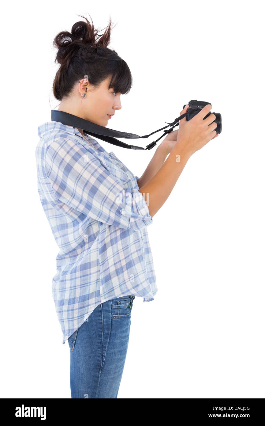 Concentrated young woman taking picture with her camera Stock Photo - Alamy