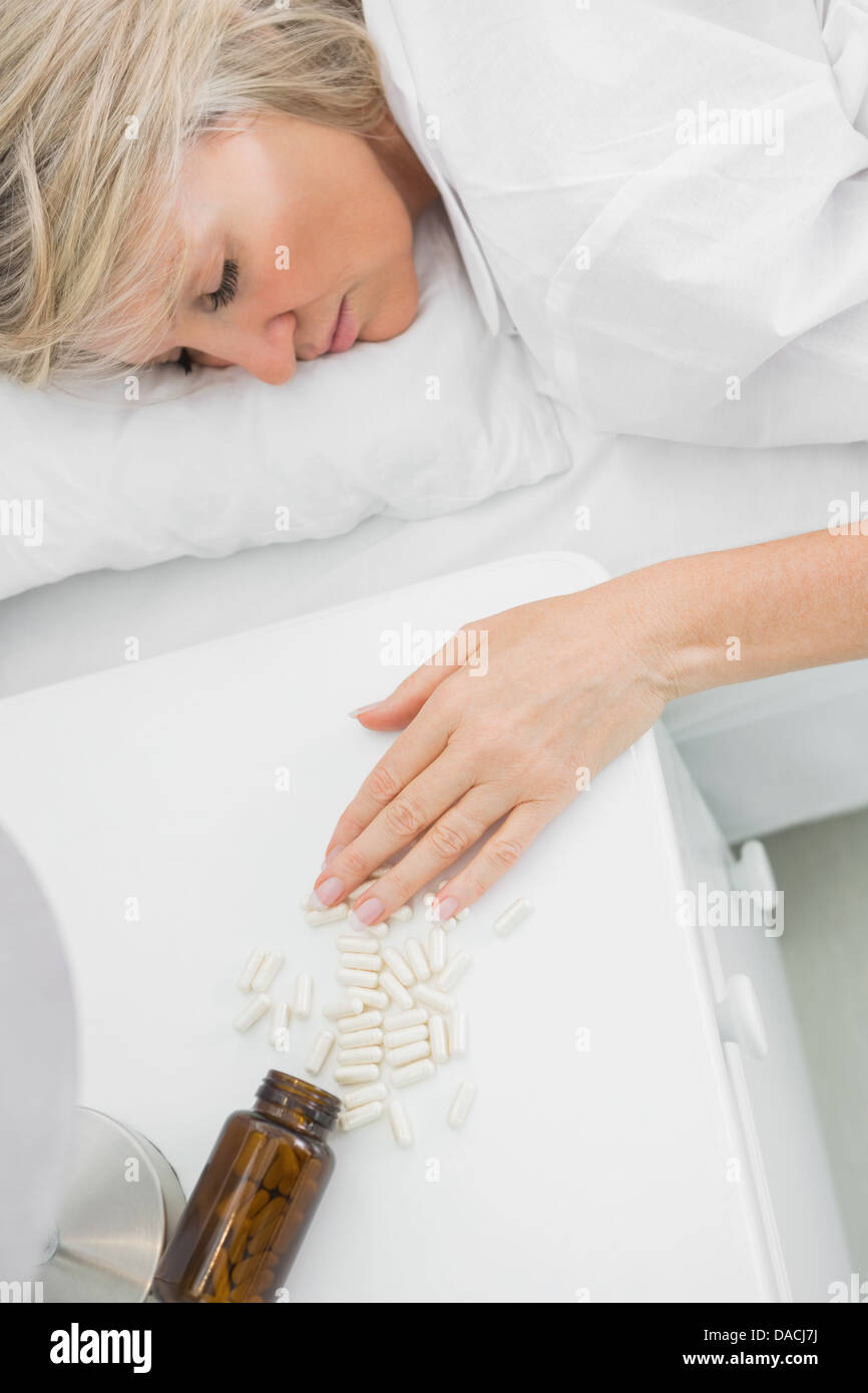Blonde woman lying motionless after overdosing on pills Stock Photo - Alamy