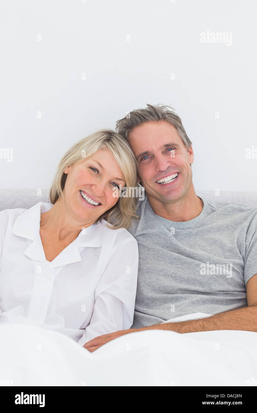 Smiling couple in bed Stock Photo - Alamy