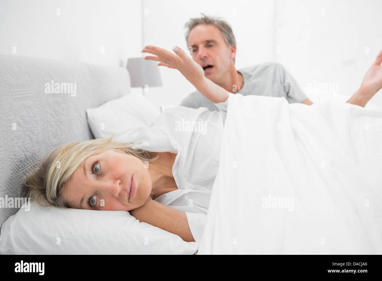 Woman refusing to listen to partner during a fight in bed Stock Photo ...