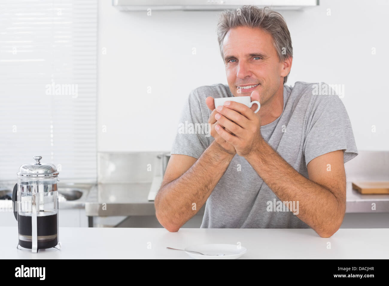 Man having coffee in kitchen Stock Photo - Alamy