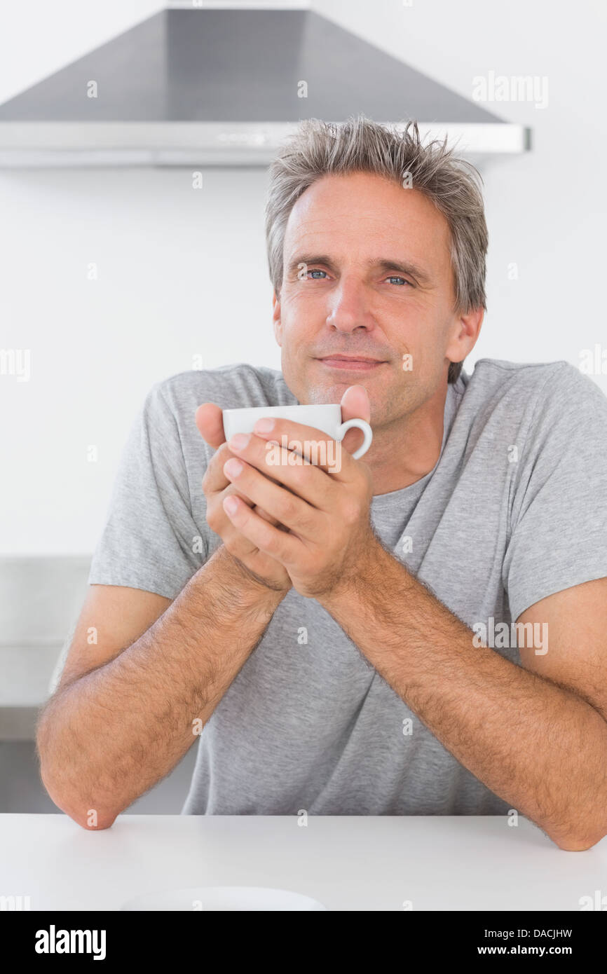 Man having coffee in kitchen in the morning Stock Photo - Alamy