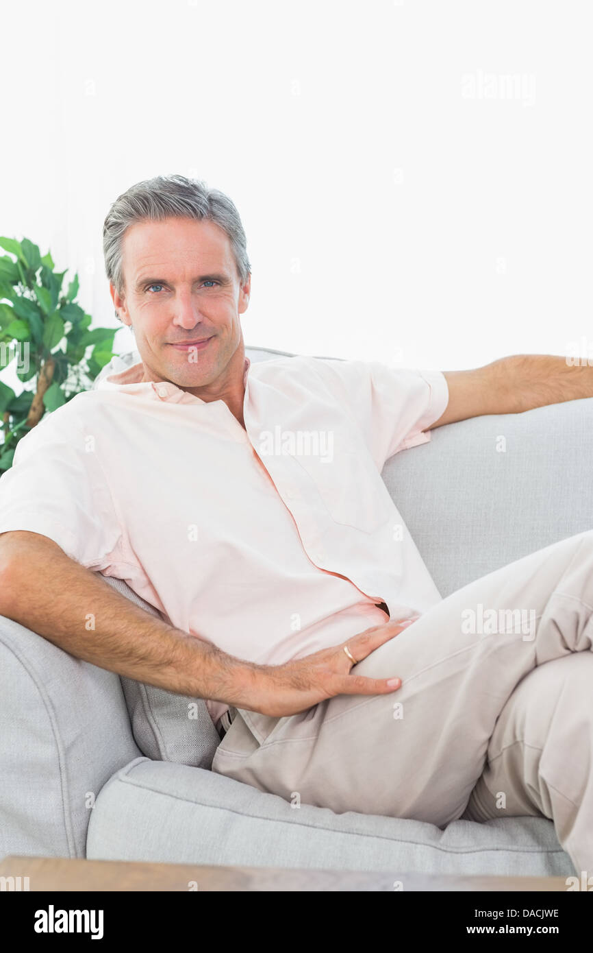 Happy man relaxing on his couch Stock Photo - Alamy