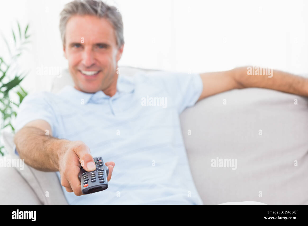 Man on couch tv hi-res stock photography and images - Alamy