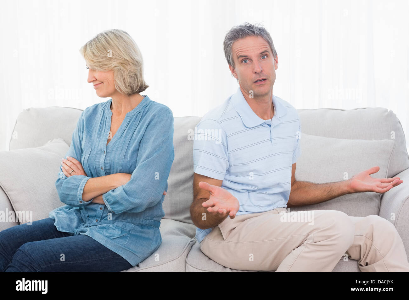 Couple not taking after a fight and man looking confused at camera ...