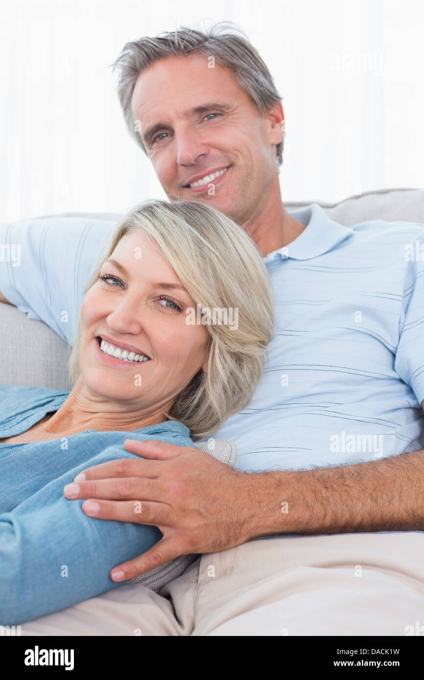 Smiling couple relaxing at home Stock Photo - Alamy