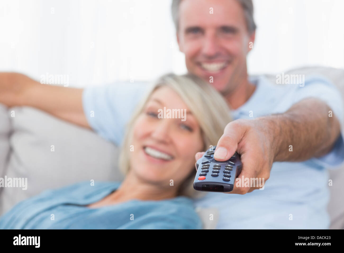 Happy woman watching tv home hi-res stock photography and images - Alamy