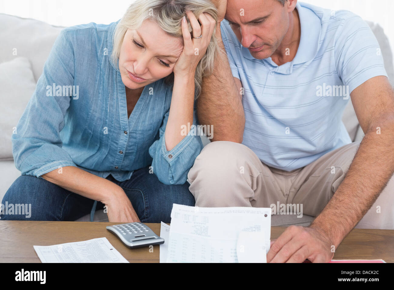 Worried couple going over bills Stock Photo - Alamy