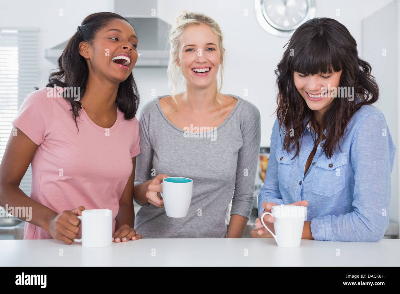 Happy friends having coffee together Stock Photo - Alamy
